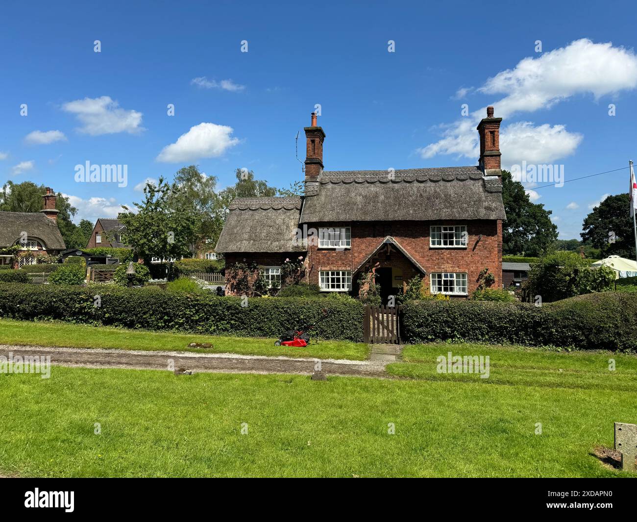 Traditional thatched cottage in a typical English Village Stock Photo ...