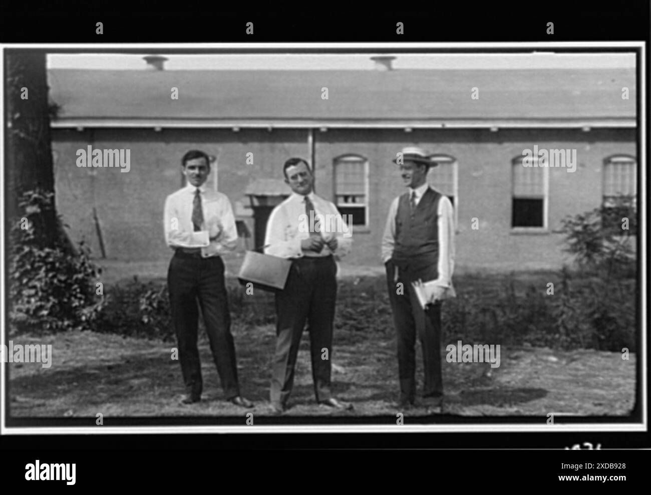 Bruce, Ned, Mr., and two unidentified men, standing outdoors. Genthe ...