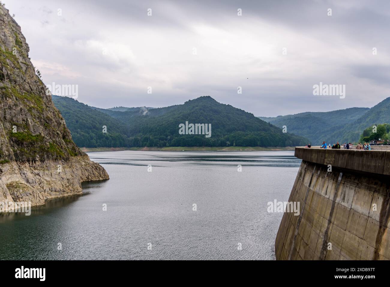 A scenic view of Vidraru Dam and the surrounding areas under a cloudy ...