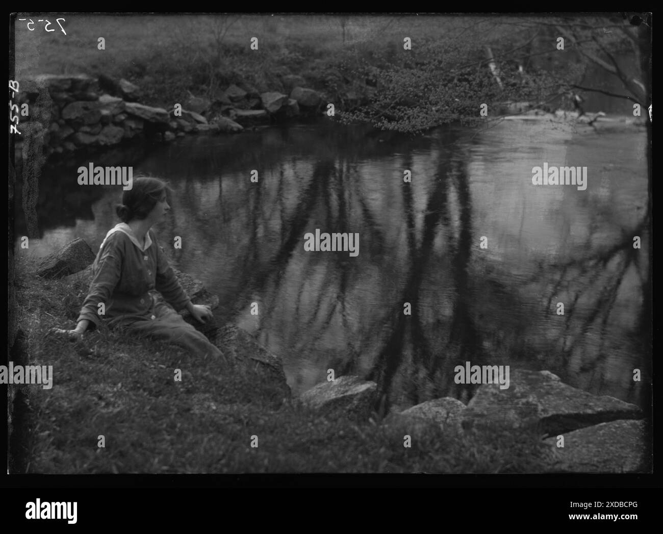 Millay, Edna St. Vincent, Miss, seated next to a pond. Genthe ...