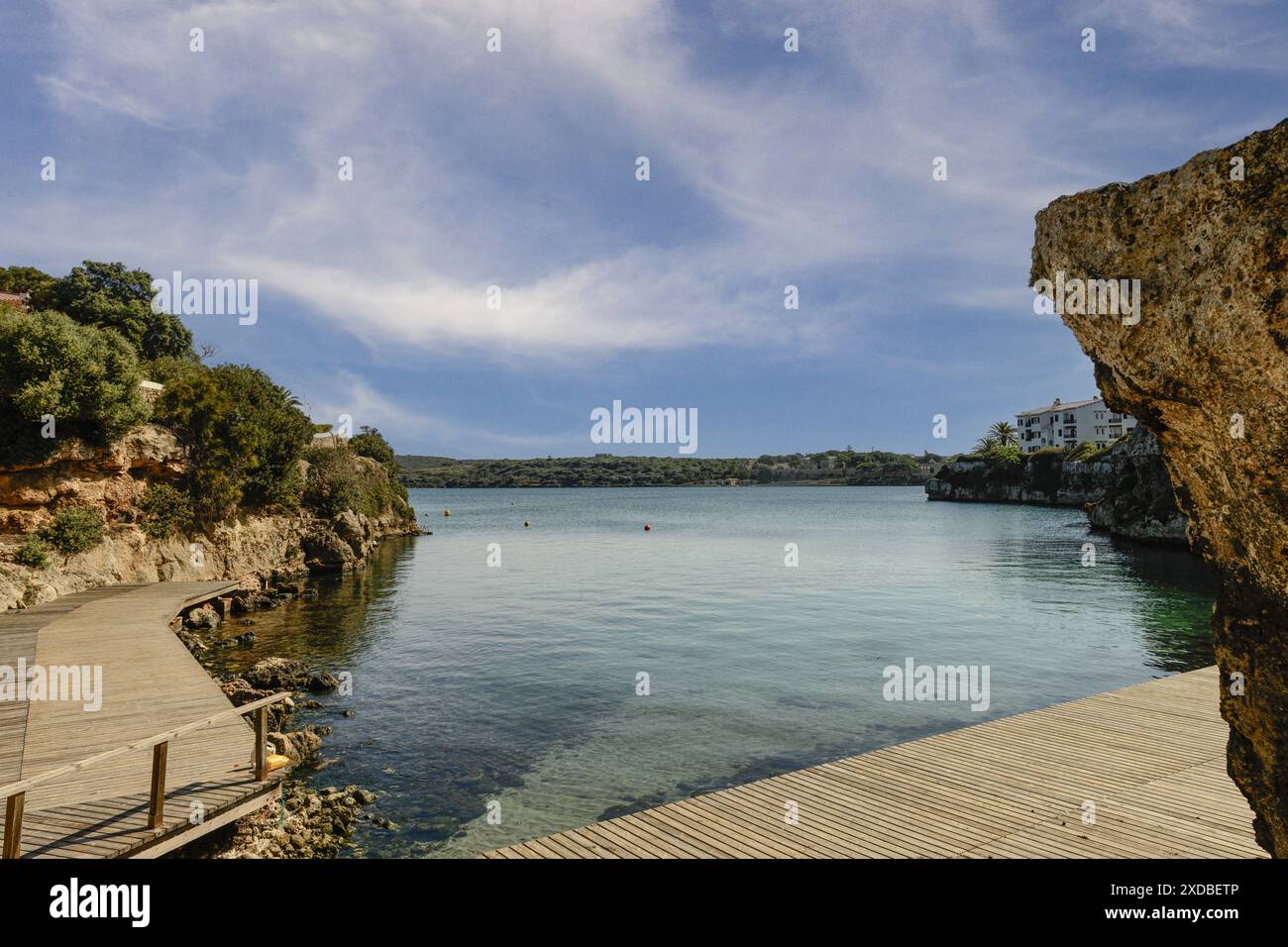 A serene view of Playa Secreta cove in Menorca, featuring clear blue ...
