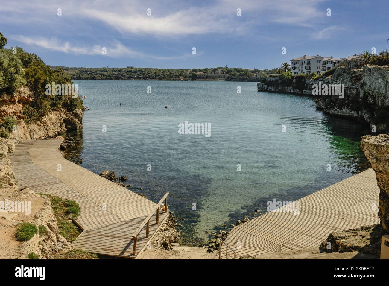 A serene view of Playa Secreta cove in Menorca, featuring clear blue ...