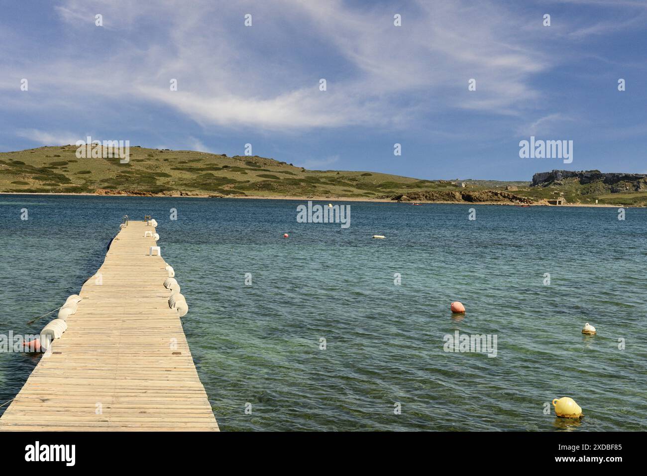 A charming wooden pier stretching into the clear waters of Puerto ...