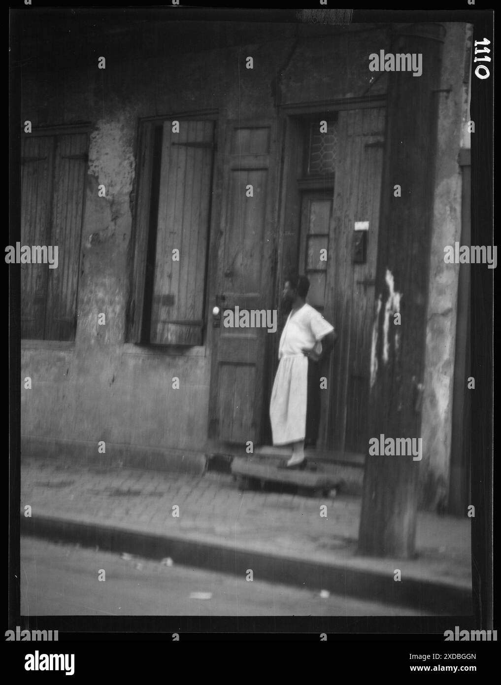 Woman standing in a doorway in the French Quarter, New Orleans. Genthe ...