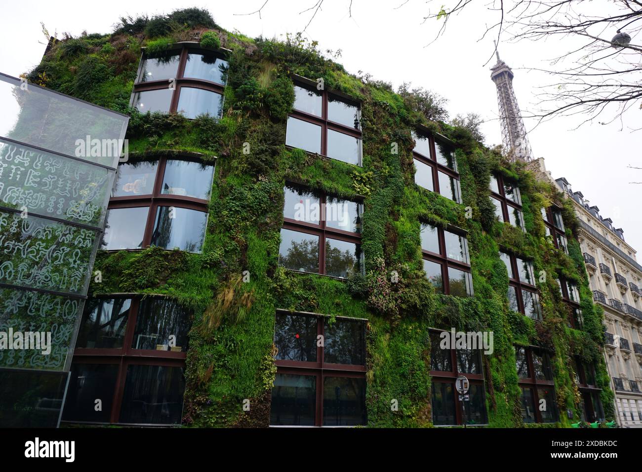 green building in Paris France covered with vegetation by the eiffel ...