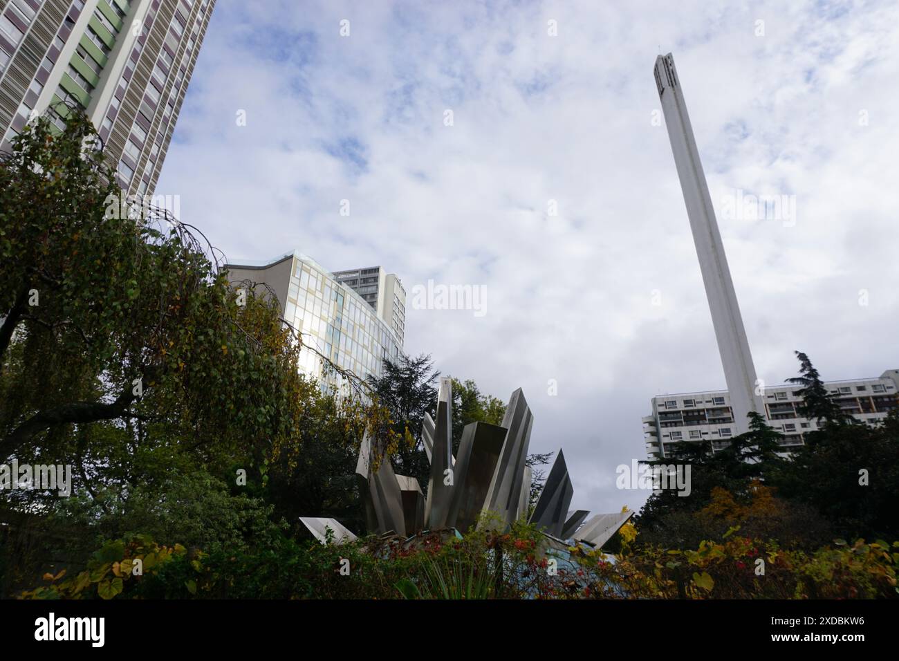 colorful buildings in Paris France with metal sculpture in the park ...