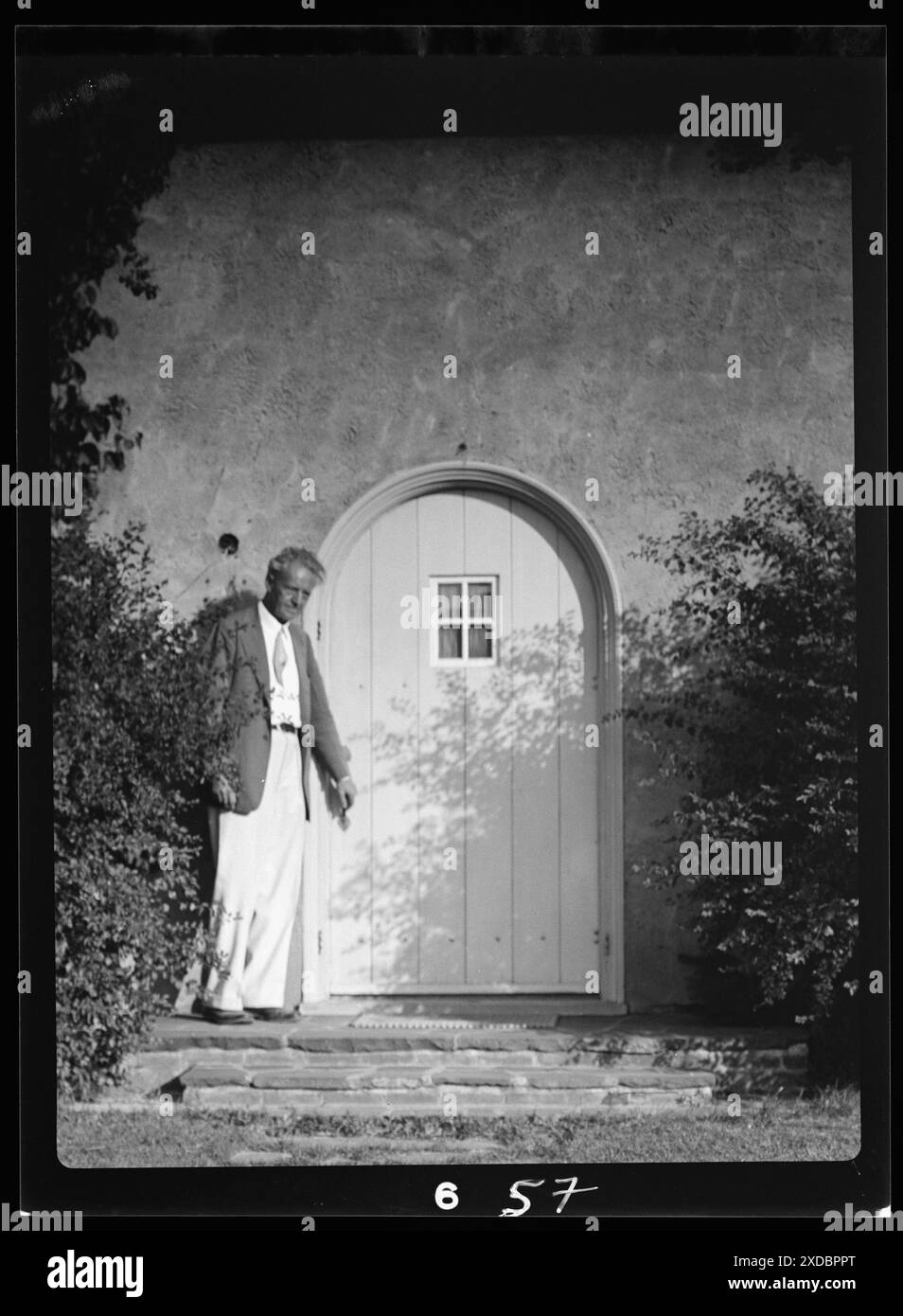 Arnold Genthe standing outside by a door. Genthe photograph collection ...