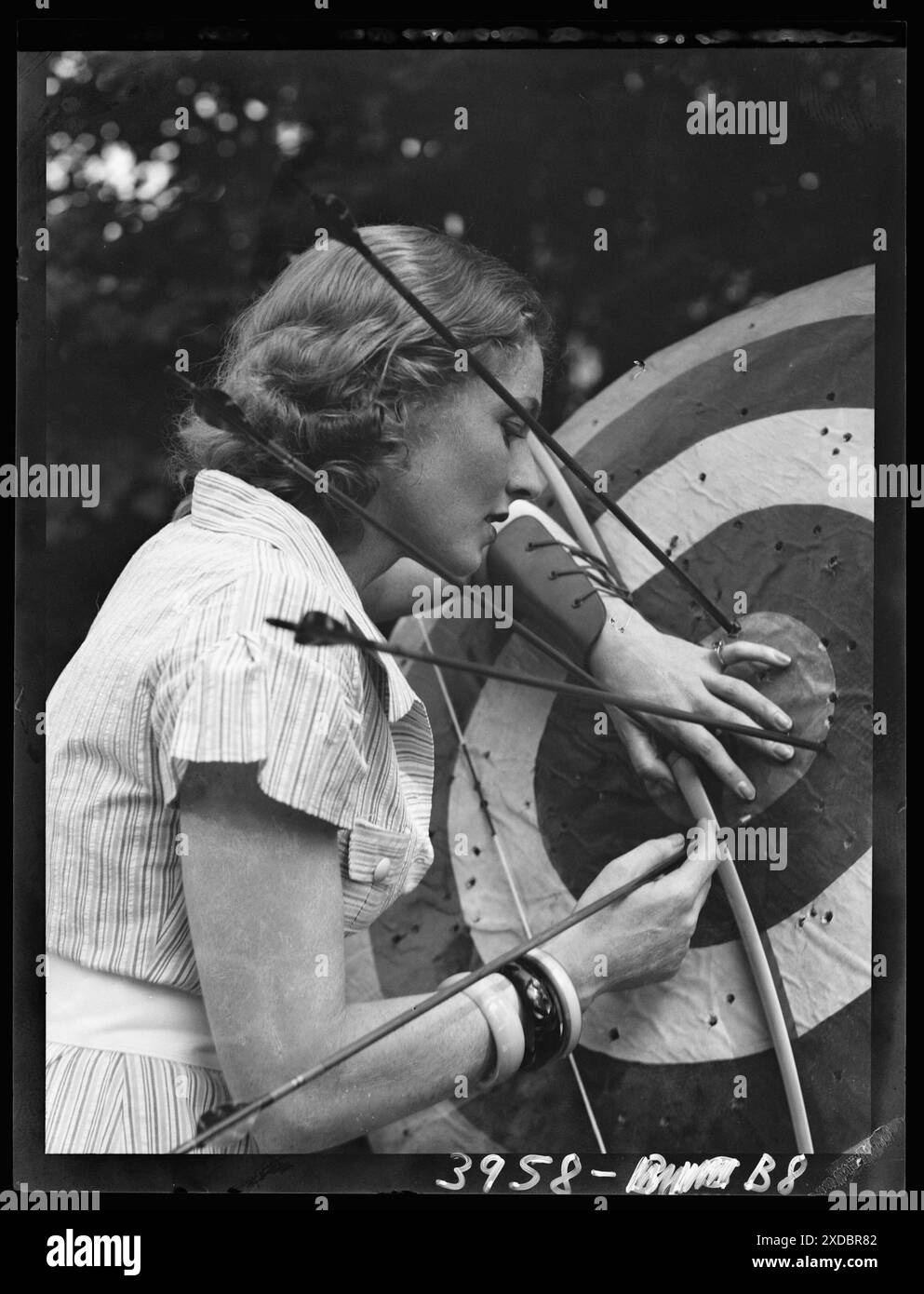 Chase, Diana, Miss, doing archery. Genthe photograph collection Stock ...