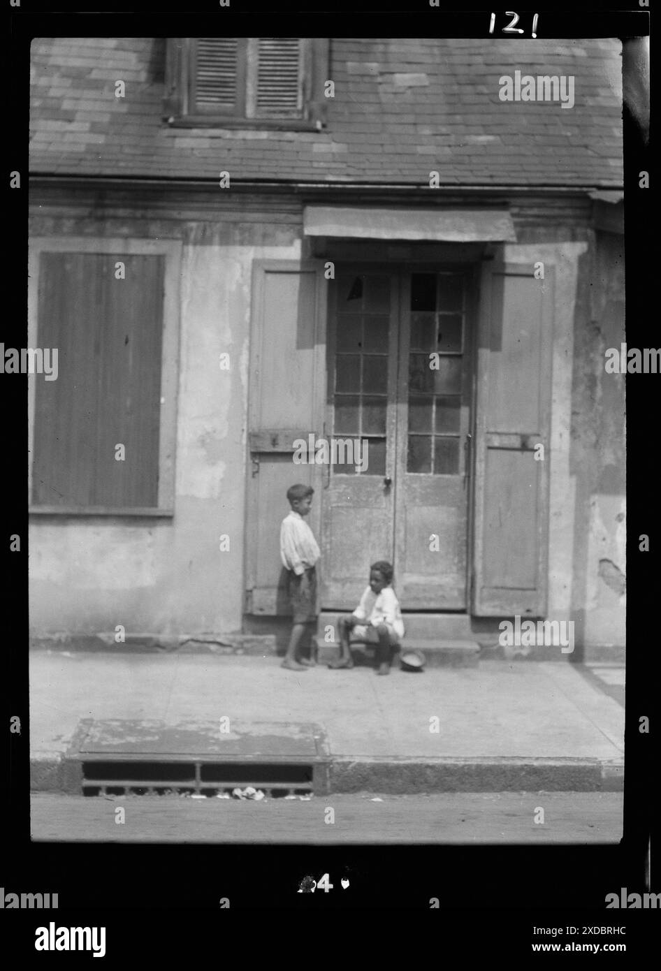 Two children outside a door with shutters in the French Quarter, New ...