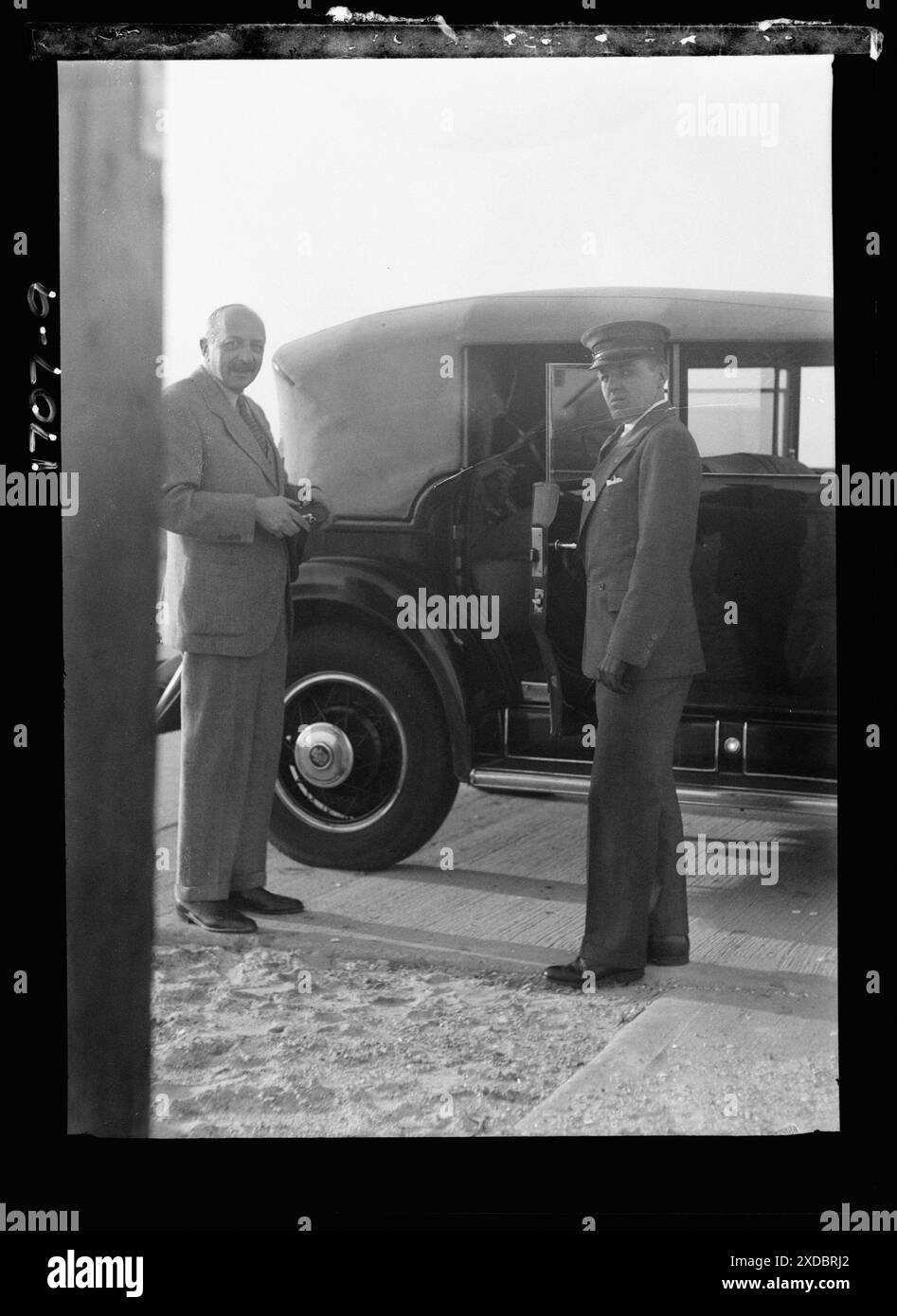 Rothbart, Albert, Mr., standing by his car with his chauffeur. Genthe ...