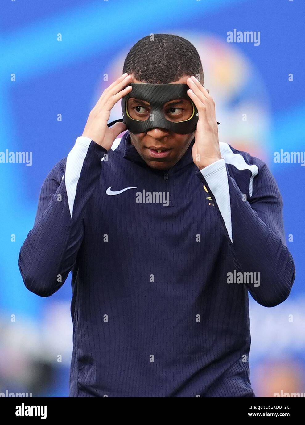 France's Kylian Mbappe with a protective mask on his face as he warms ...