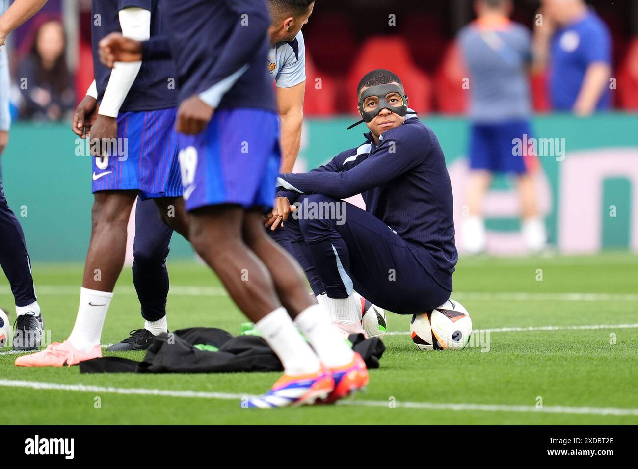 France's Kylian Mbappe (right) with a protective mask on his face as he ...