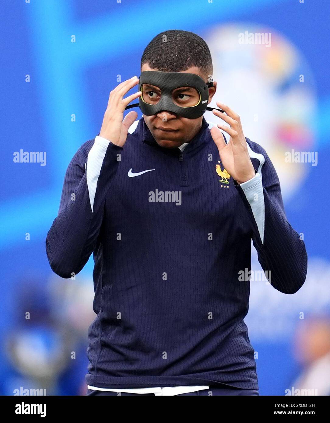 France's Kylian Mbappe with a protective mask on his face as he warms ...