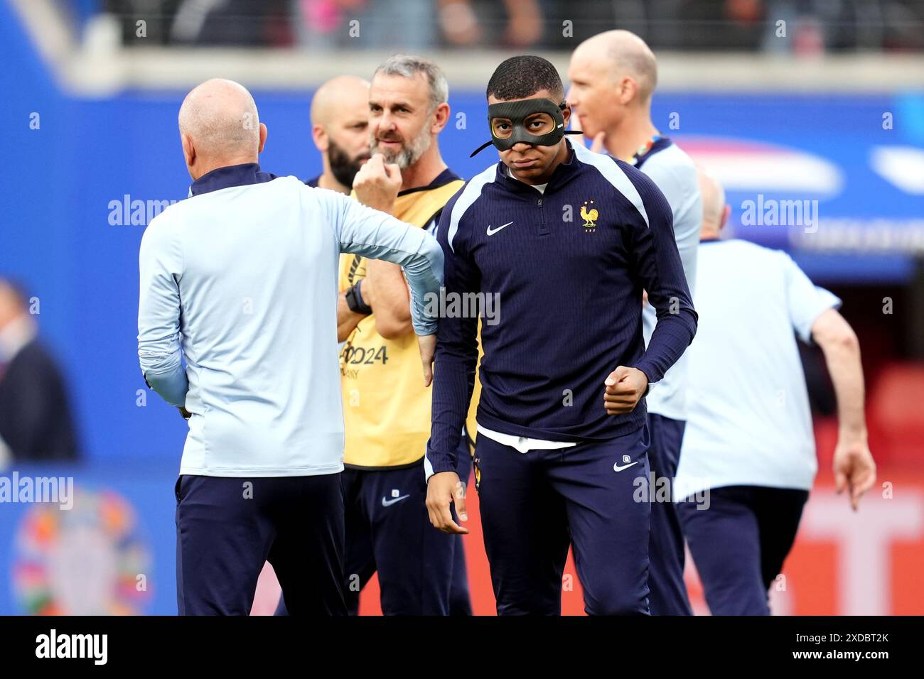 France's Kylian Mbappe (centre) with a protective mask on his face as ...