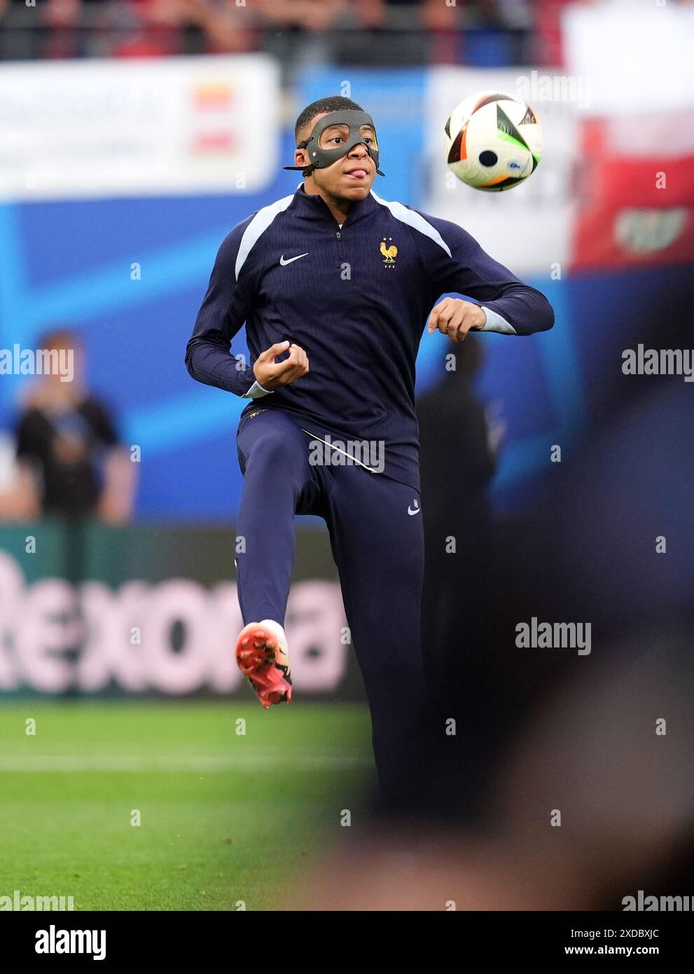 France's Kylian Mbappe with a protective mask on his face as he warms ...