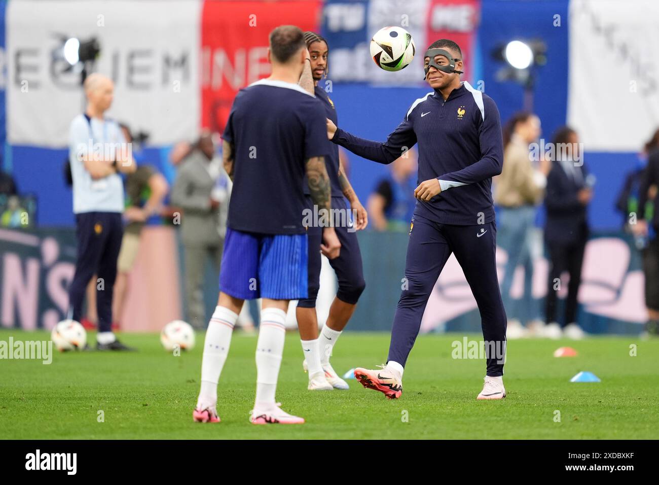 France's Kylian Mbappe (right) with a protective mask on his face as he ...