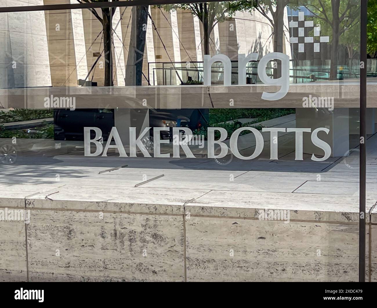 Houston, Texas, USA - April 4, 2024: The signage for nrg and BAKER BOTTS outside their office in ...