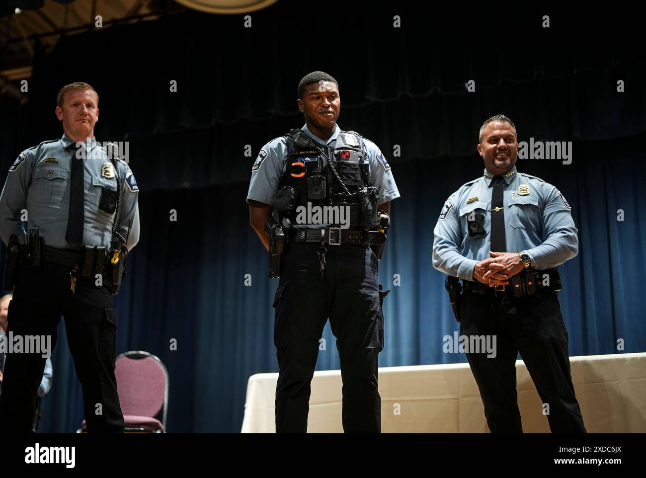 FILE - Officer Jamal Mitchell, center, is presented with a Lifesaving ...