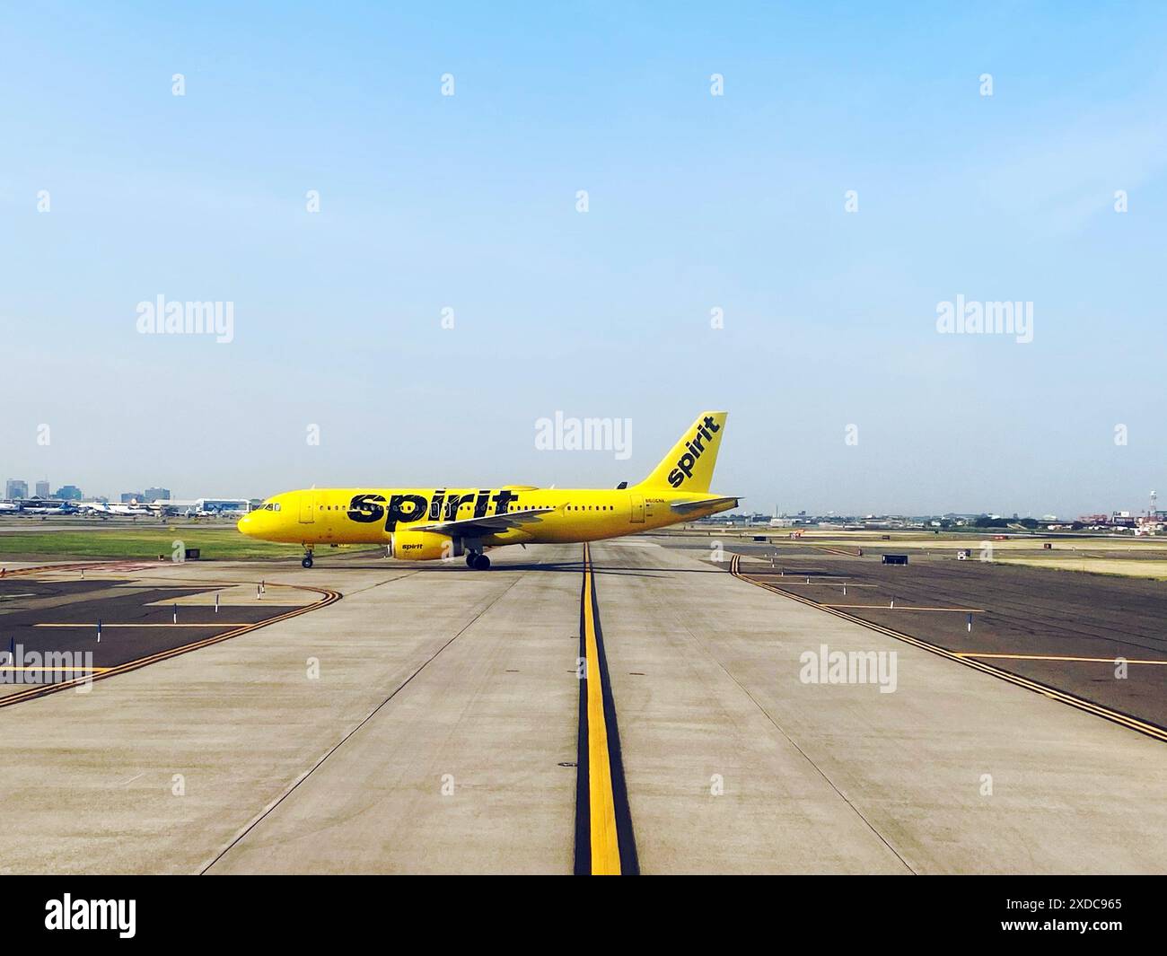 A Spirit Airlines airplane on the runway at an airport, Spirit plane ...