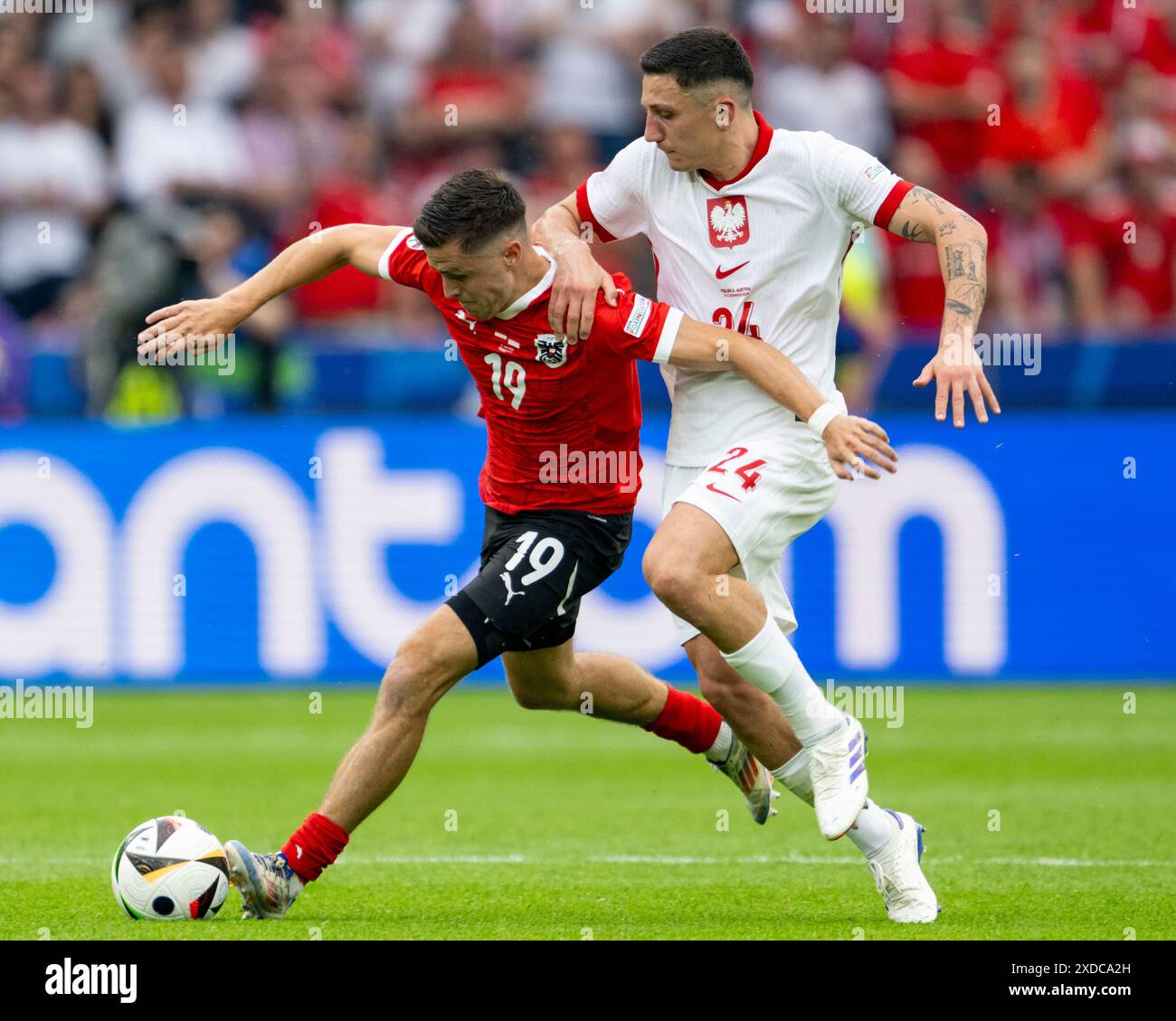 Berlin, Germany. 21st June, 2024. Christoph Baumgartner of Austria and Bartosz Slisz of Poland ...