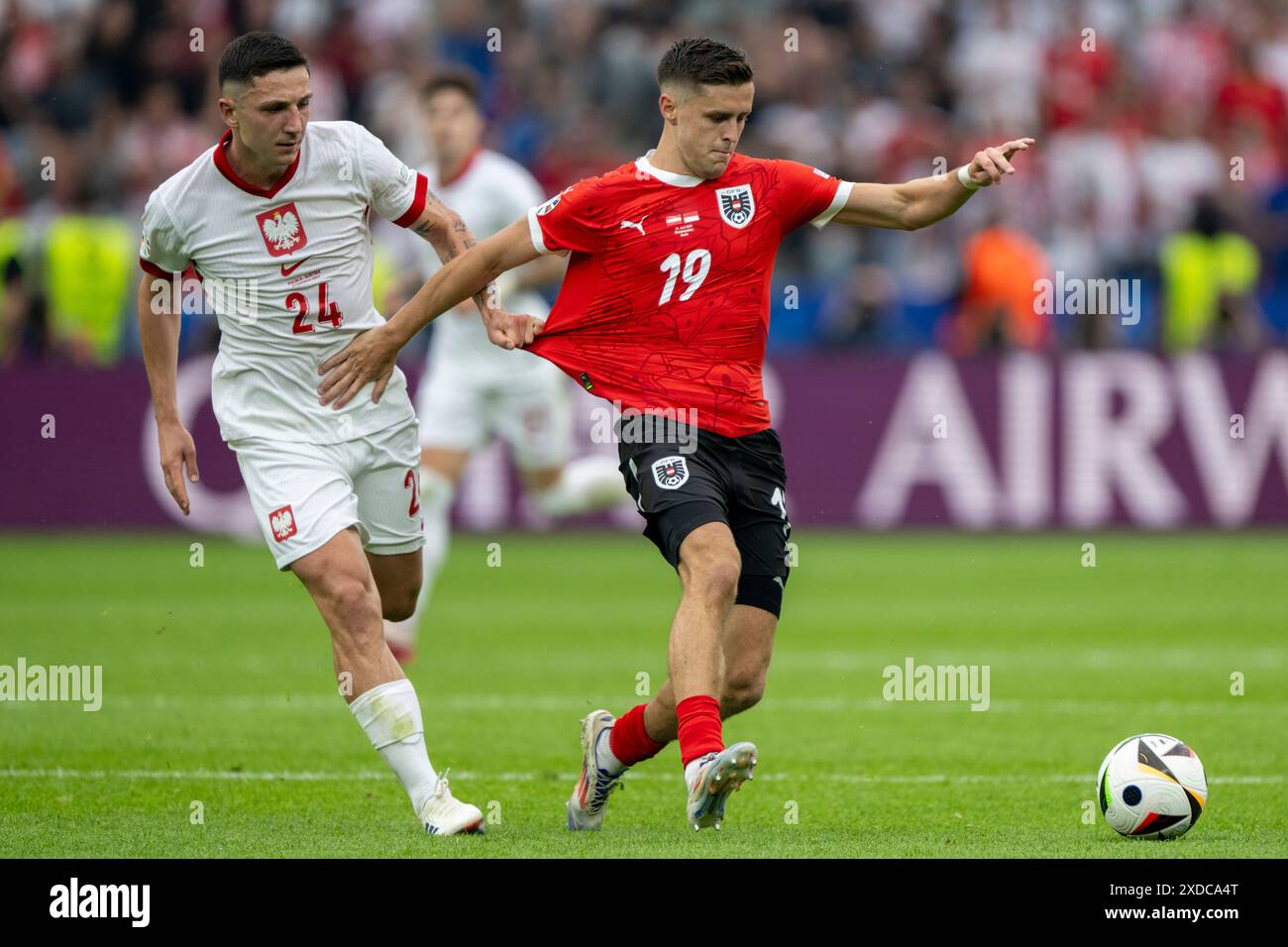 Berlin, Germany. 21st June, 2024. Christoph Baumgartner of Austria and Bartosz Slisz of Poland ...