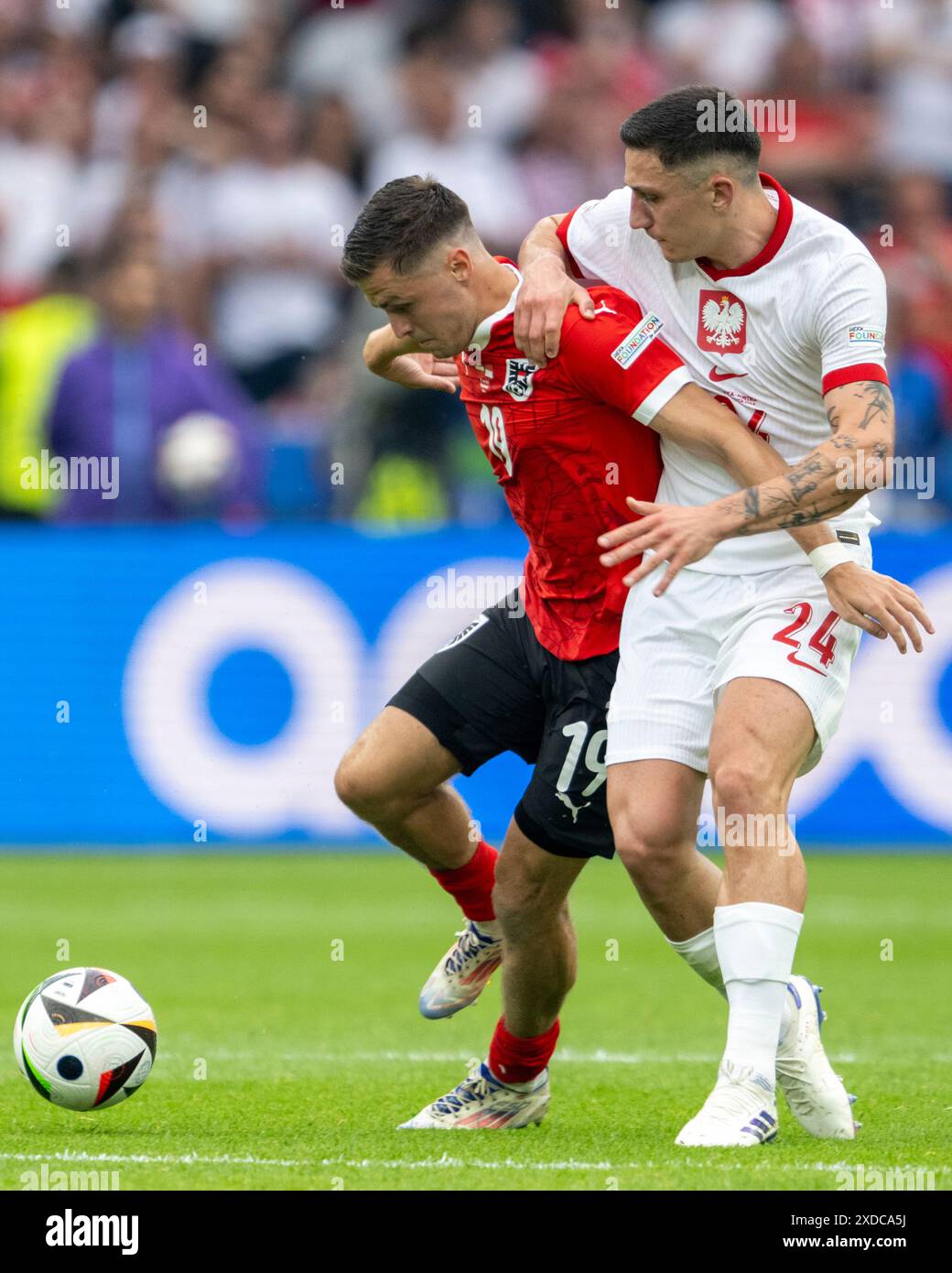 Berlin, Germany. 21st June, 2024. Christoph Baumgartner of Austria and Bartosz Slisz of Poland ...