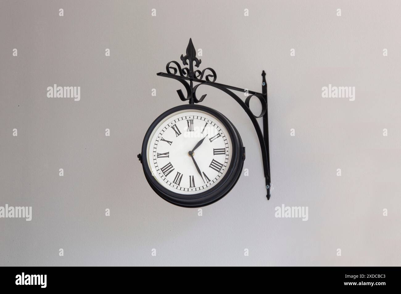 Close-up detail of black old city clock in home interior on white ...