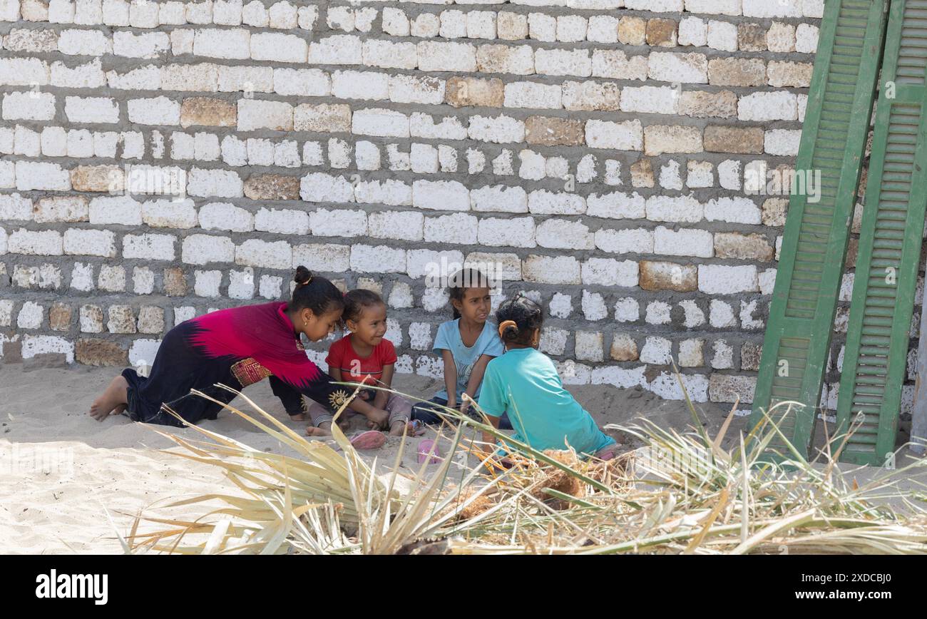 Four little Egyptian girls in modern dress playing in the sand at Bisaw ...