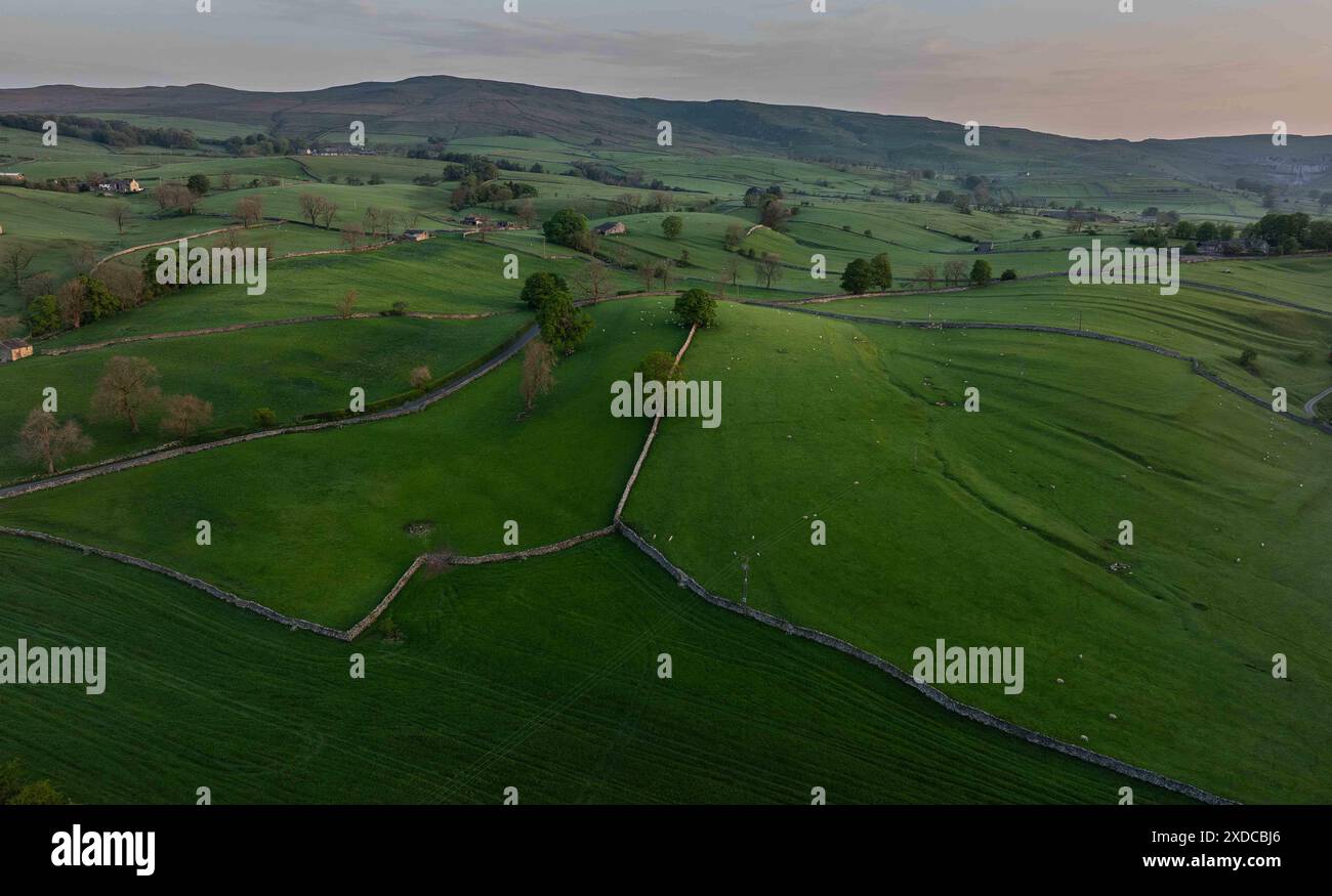 The early evening light gently illuminates the undulating terrain of ...