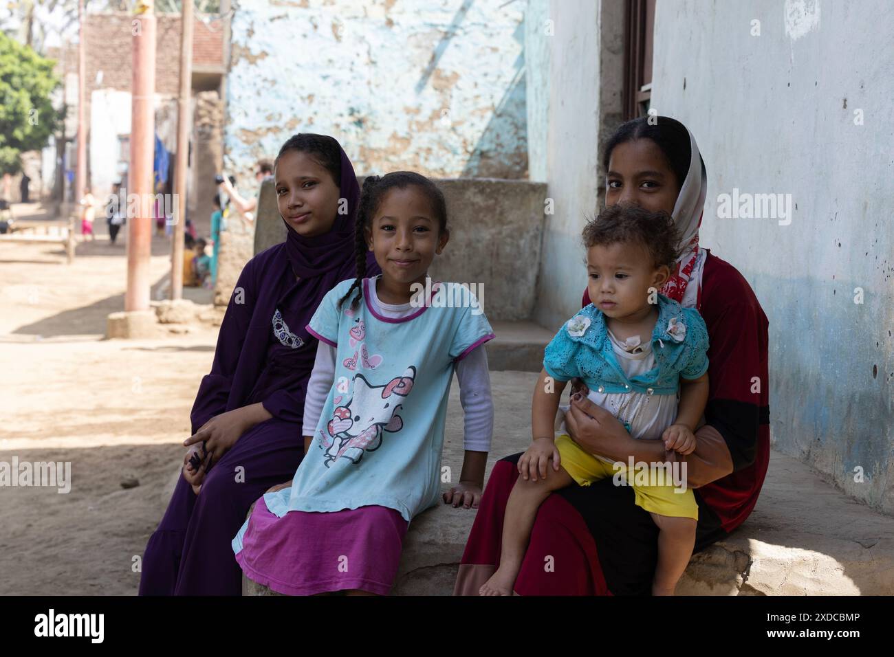 Three demure Egyptian girls and a baby pose shyly in Bisaw, a village ...