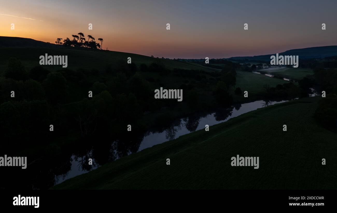 Twilight settles over the rolling hills and meandering river ...