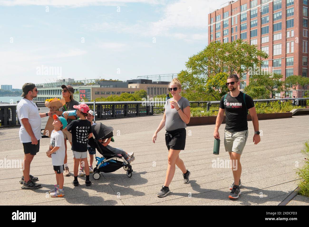Pedestrians walk on the High Line during a heat wave in Manhattan, New ...