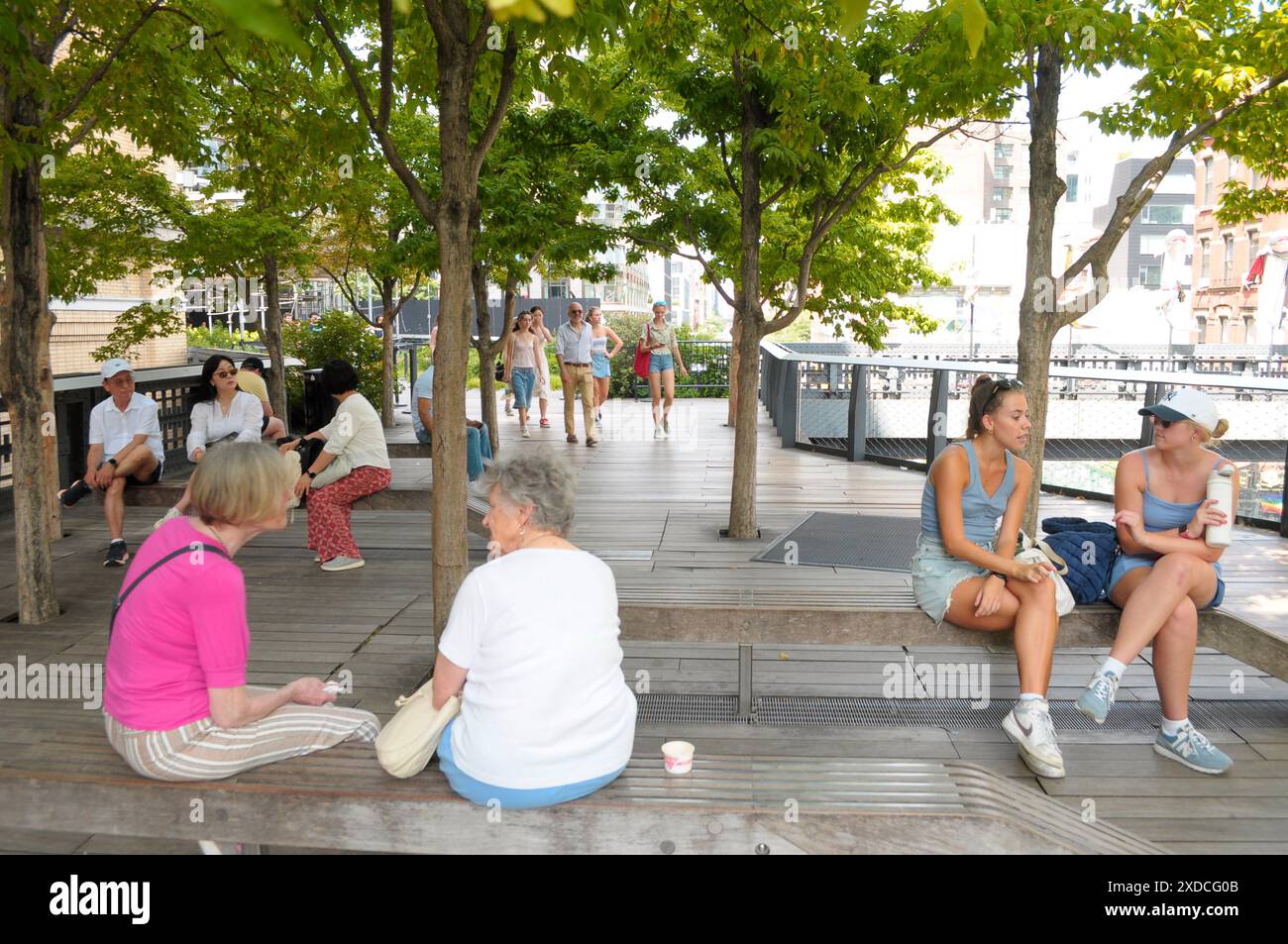 New York, USA. 20th June, 2024. Pedestrians sit in the shade on the ...