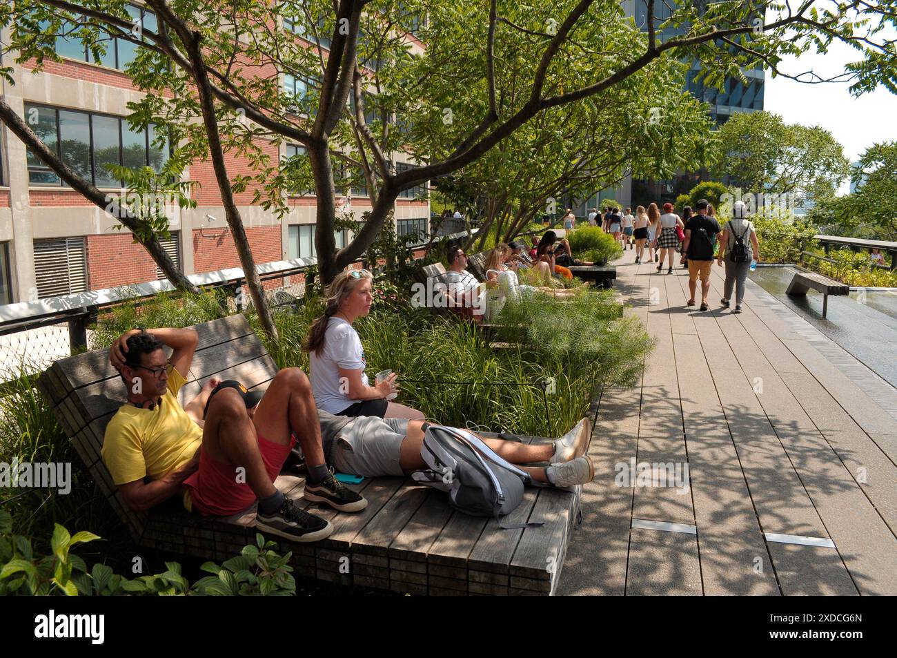 New York, USA. 20th June, 2024. Pedestrians sit in the shade on the ...