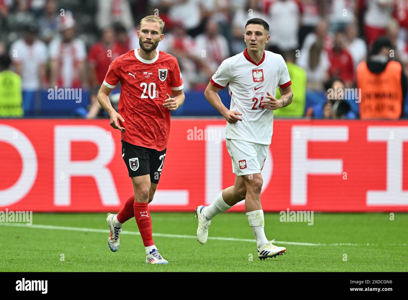 BERLIN, GERMANY - JUNE 21: Konrad Laimer of Austria and Bartosz Slisz ...