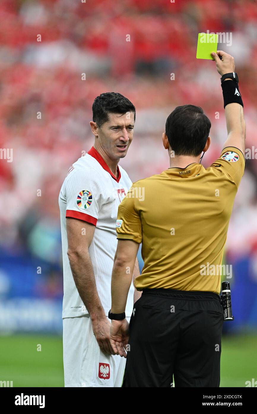 BERLIN, GERMANY - JUNE 21: Referee Umut Meler presents a yellow card to ...