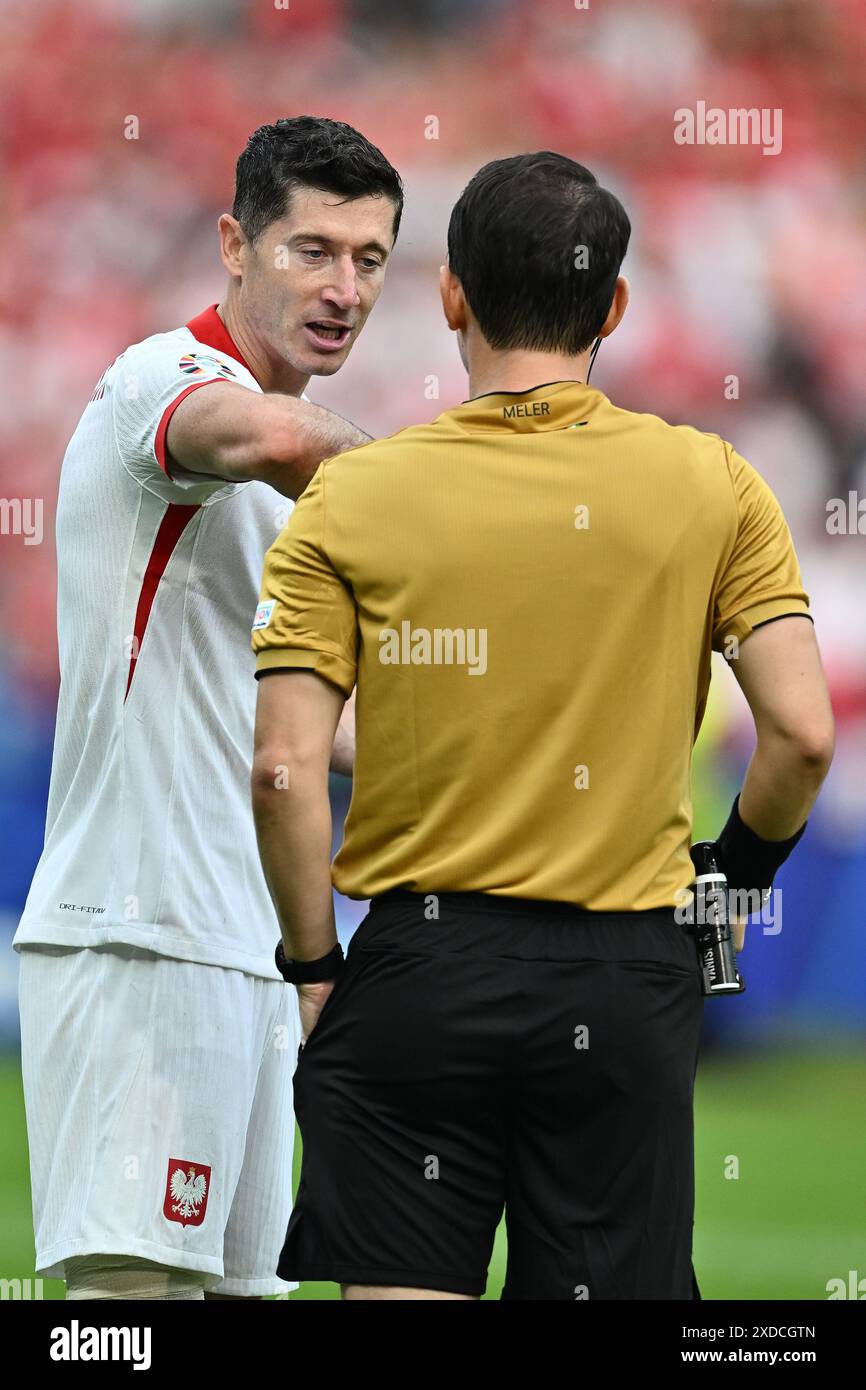 BERLIN, GERMANY - JUNE 21: Referee Umut Meler presents a yellow card to ...