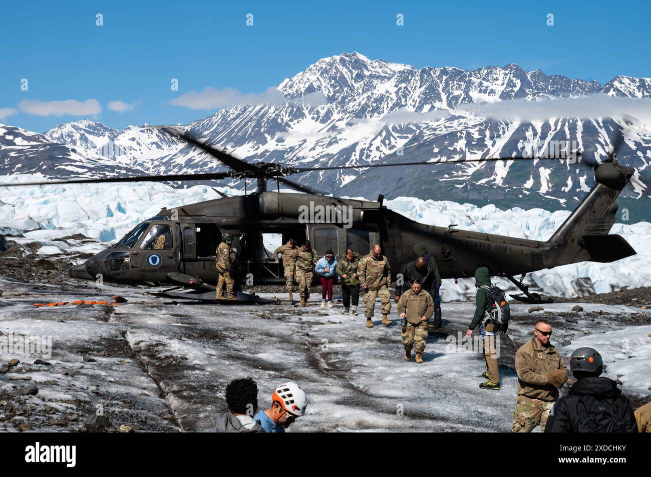 Distinguished visitors exit an Alaska National Guard UH-60L Black Hawk ...