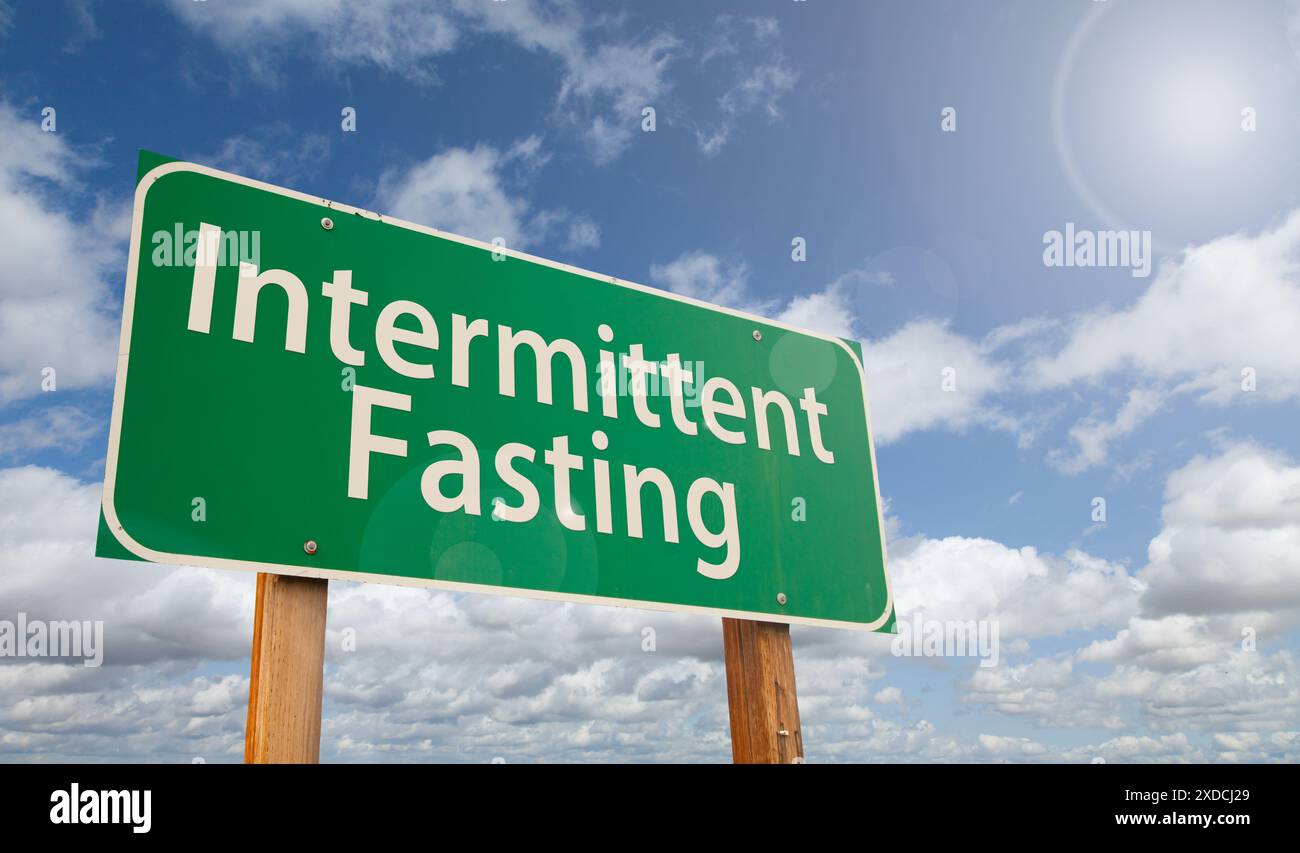 Intermittent Fasting Green Road Sign Over Clouds and Blue Sky Stock ...