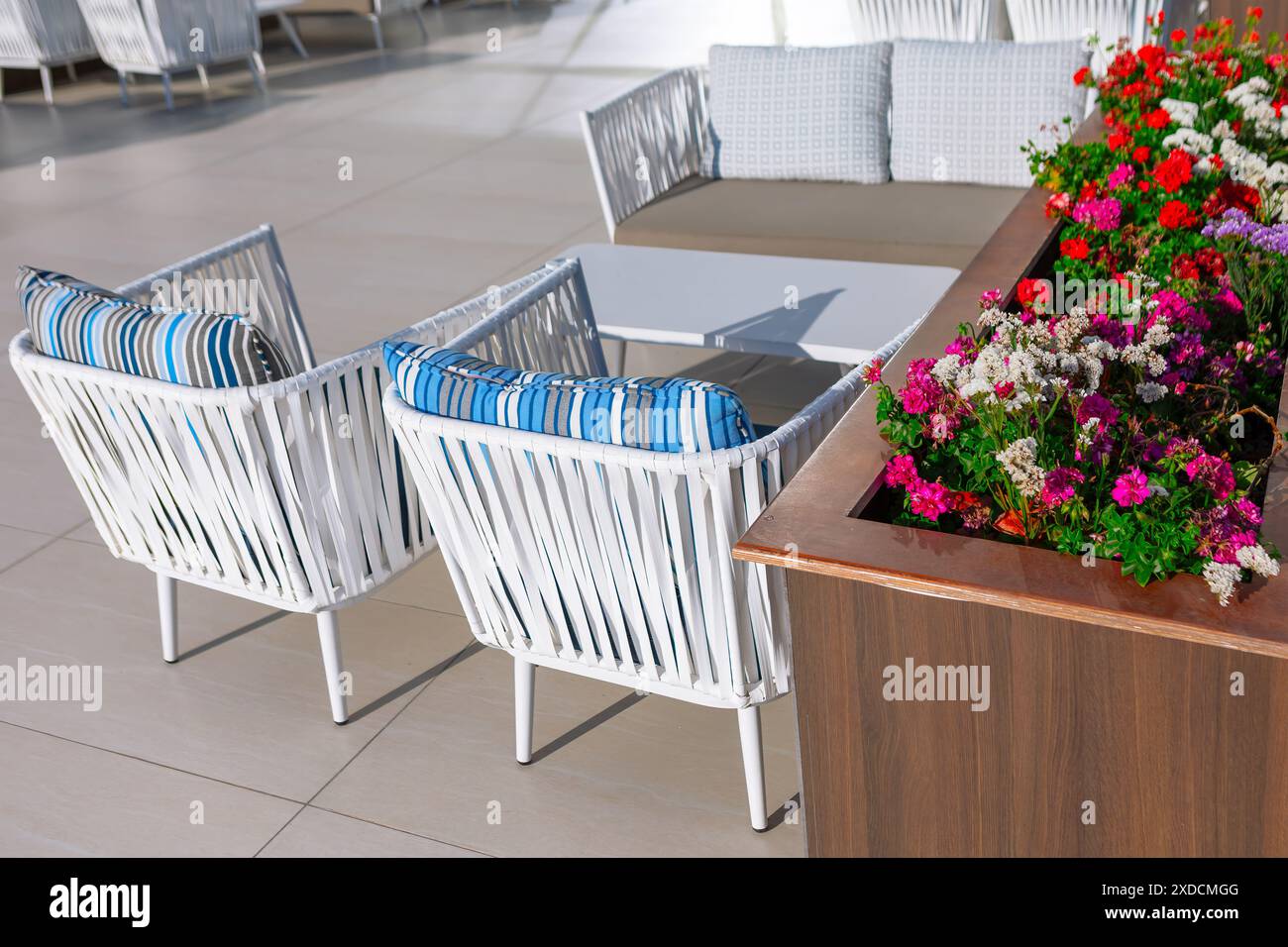Outdoor patio table and chairs with flower decoration in hotel lobby ...