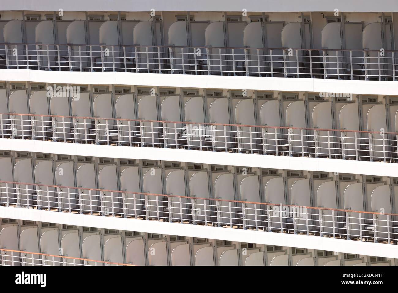 Row of empty cruise liner cabins are lined up on a balcony. The chairs ...