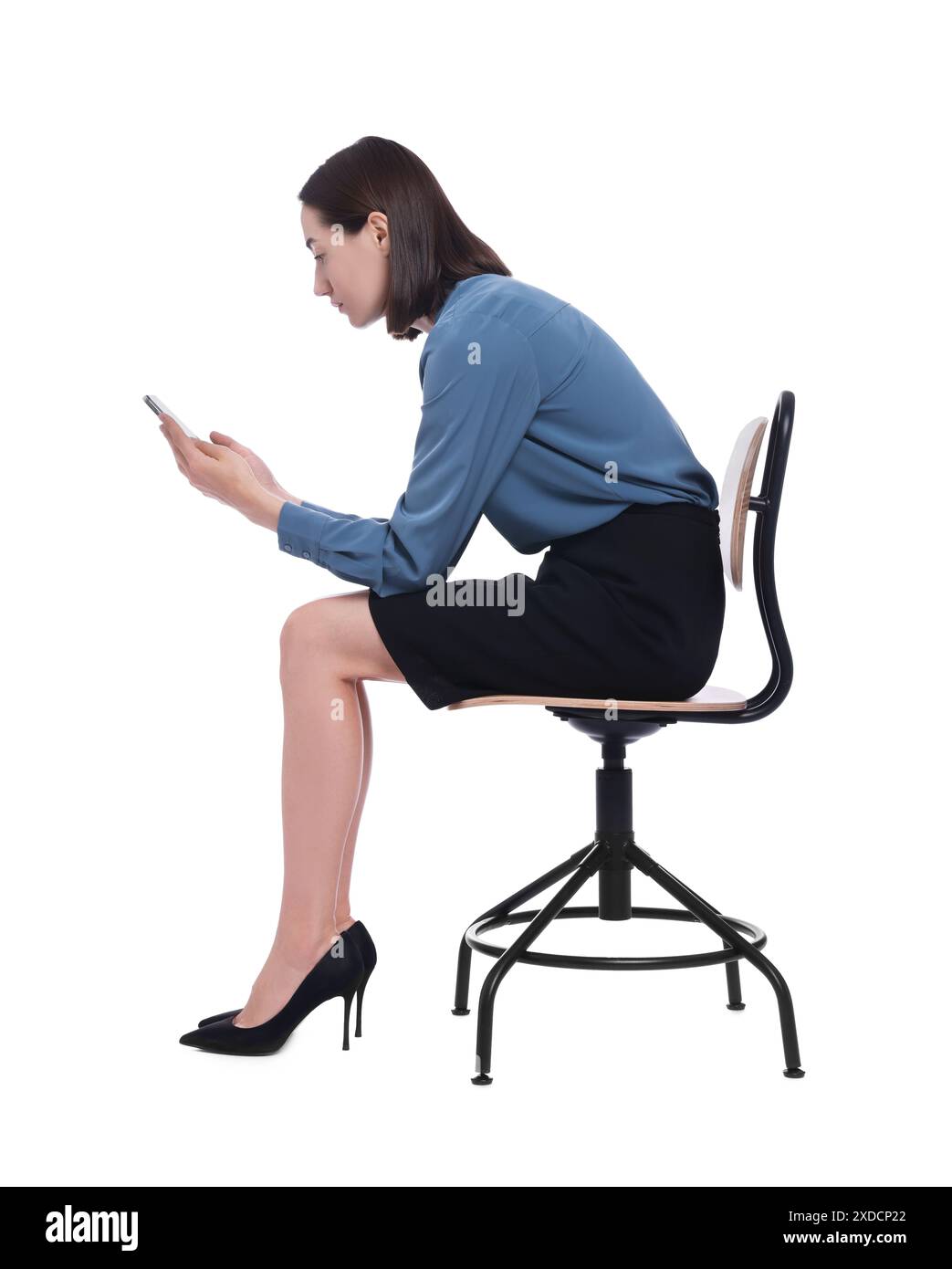 Woman with poor posture sitting on chair and using smartphone against ...