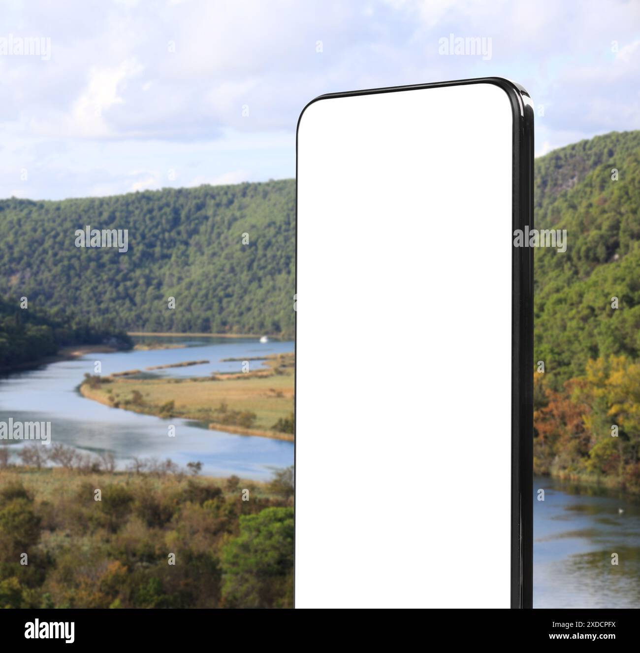 Mobile phone with empty screen against mountain landscape. Space for ...