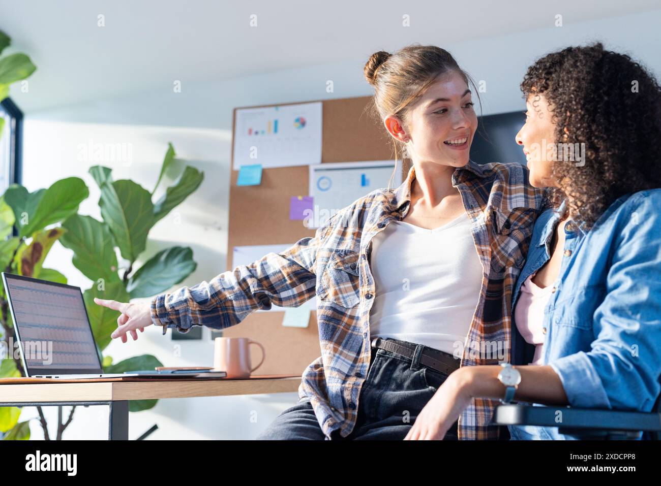 Woman smiles points screen hi-res stock photography and images - Alamy