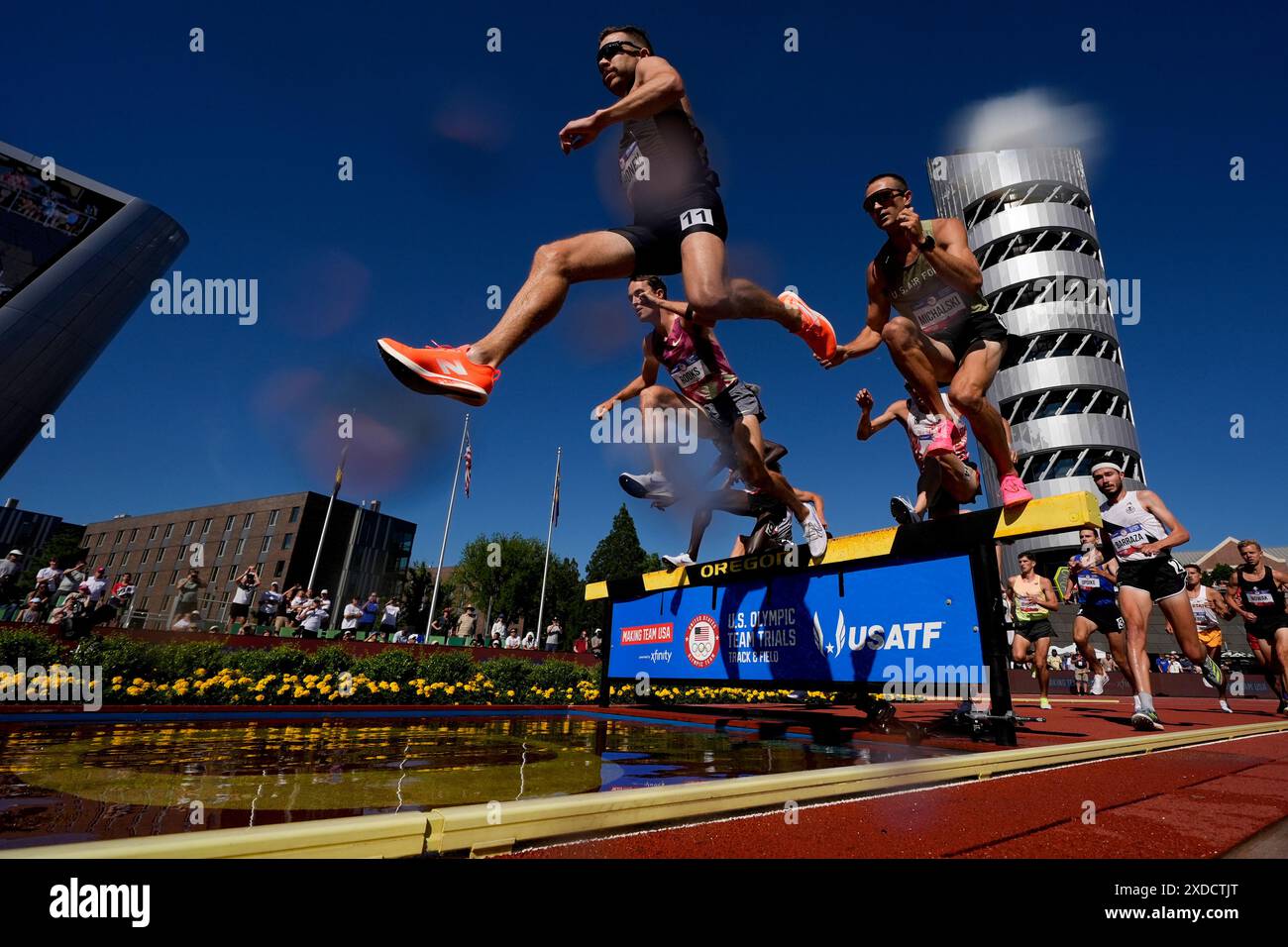 Runners competes in a heat in the men's 300-meter steeplechase during ...
