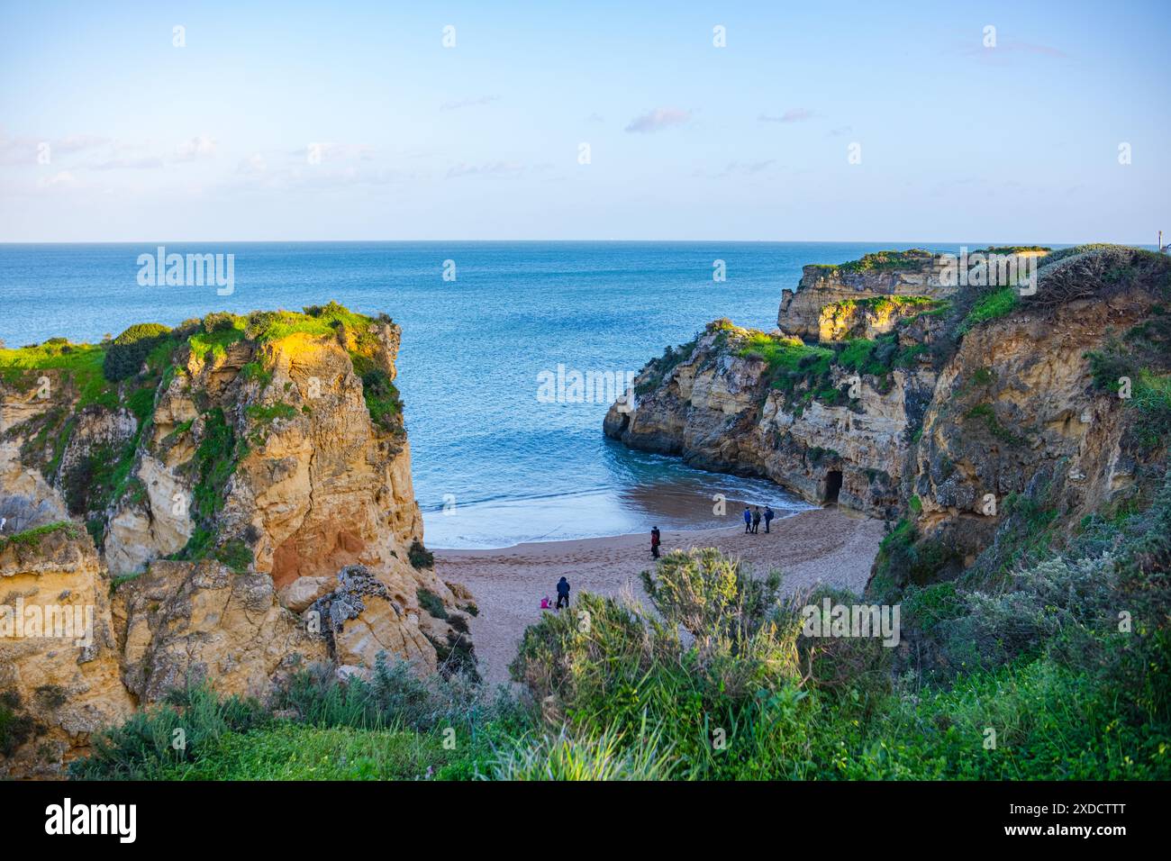 Beautiful ocean beach in Lagos "Praia da Batata" with grassy high ...
