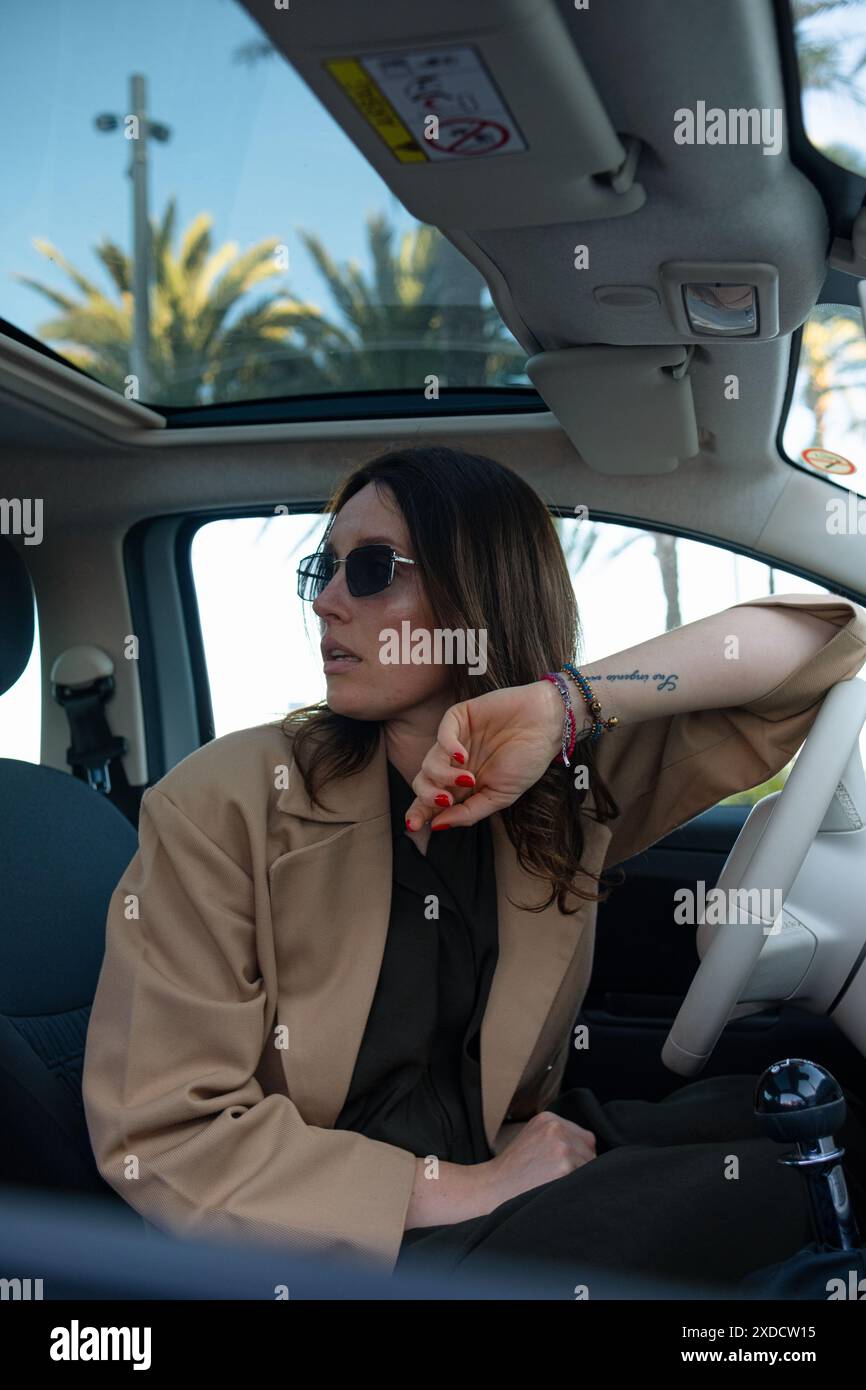 A girl driving a modern car in the south of Spain. View of the driver's ...