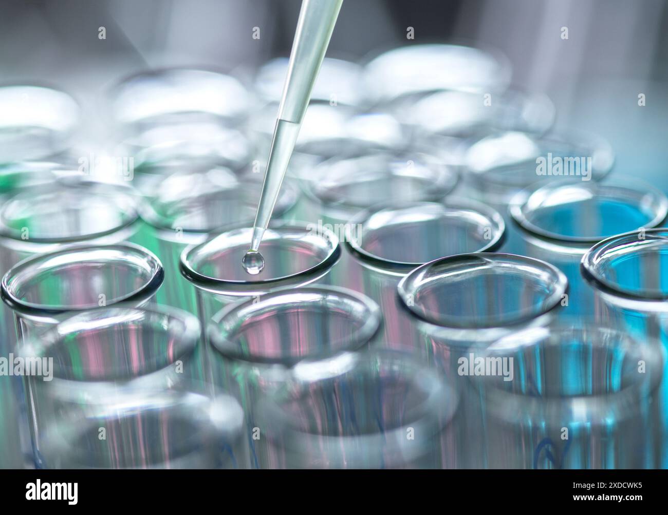 Scientist extracting samples using a pipette for analytical testing in ...