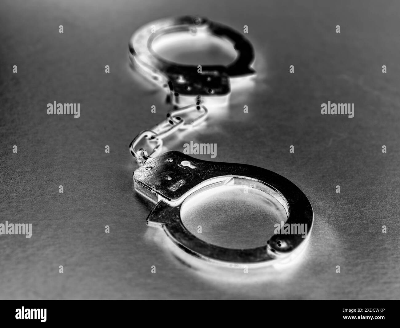 Pair of handcuffs used to contain a suspect Stock Photo - Alamy