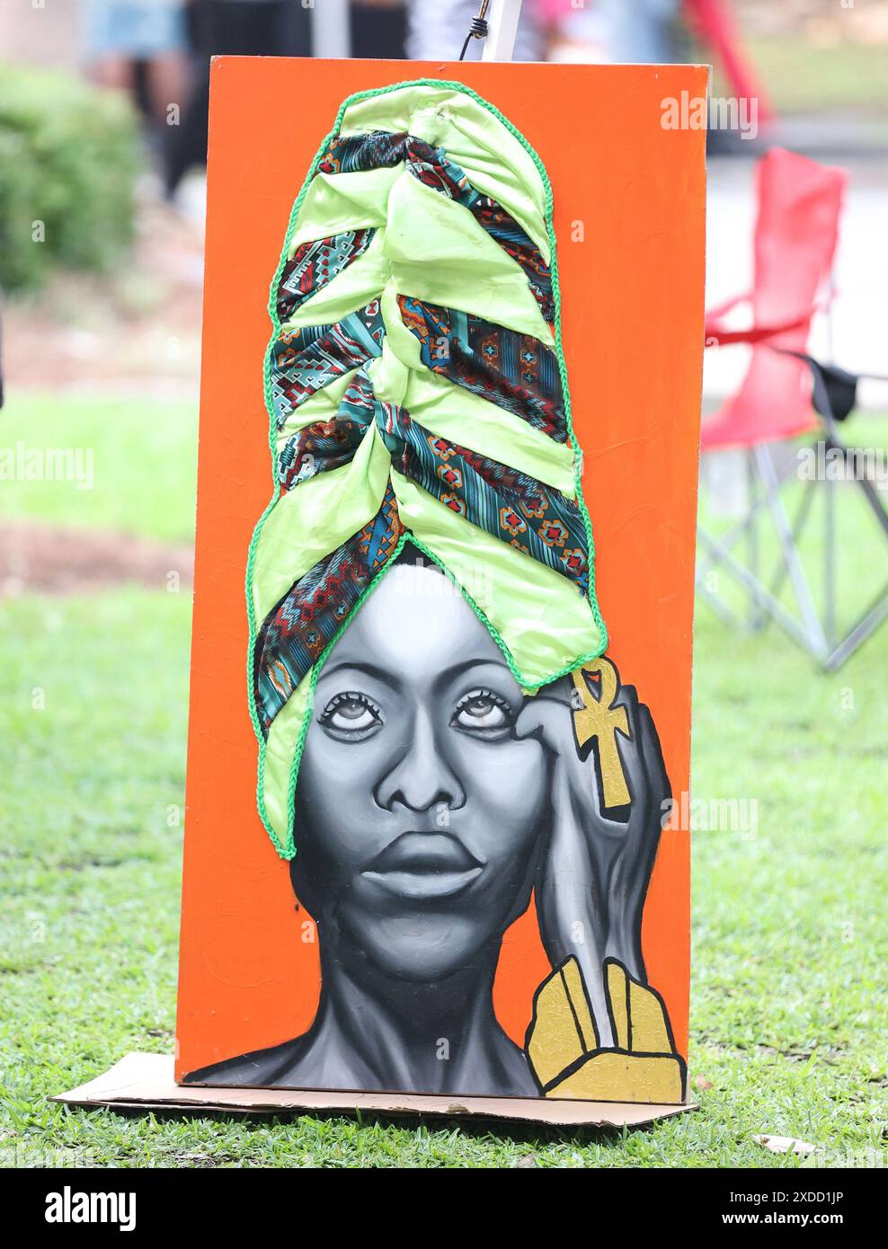 A painting of musician Erykah Badu is on display at a booth during the ...
